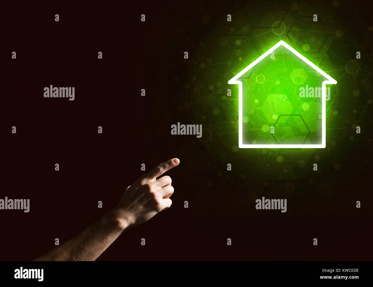 Conceptual image with hand pointing at house or main page icon on dark ...