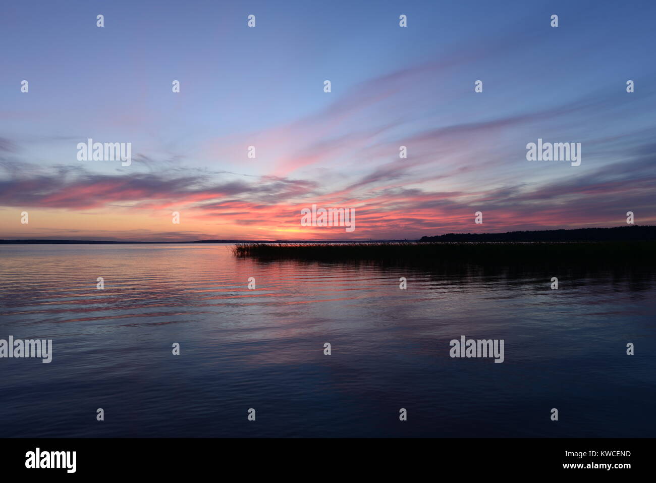Nightfall twilight light glows in the sky above the lake Stock Photo ...