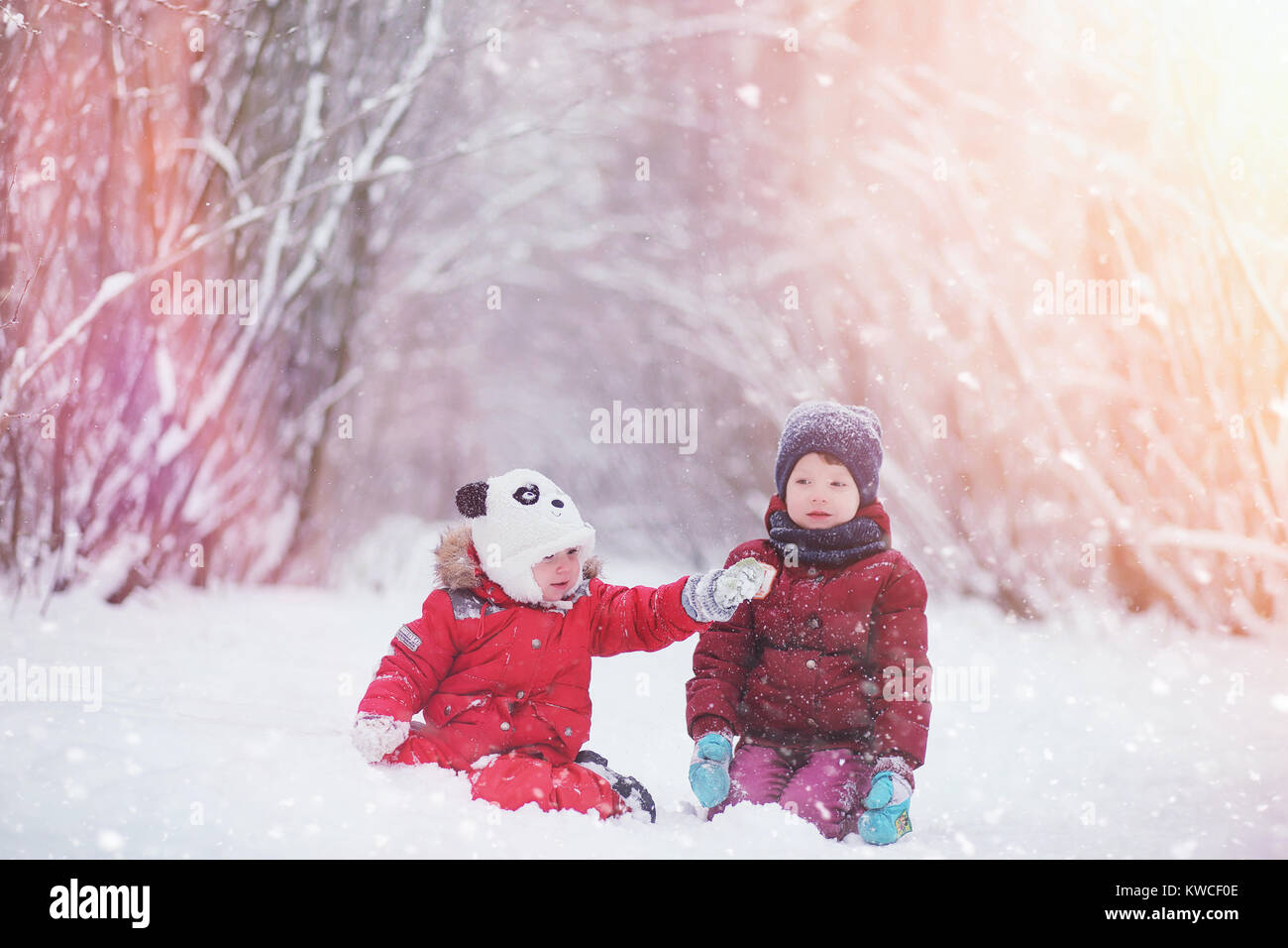 Young family with children are walking in the winter park. Winter walk ...