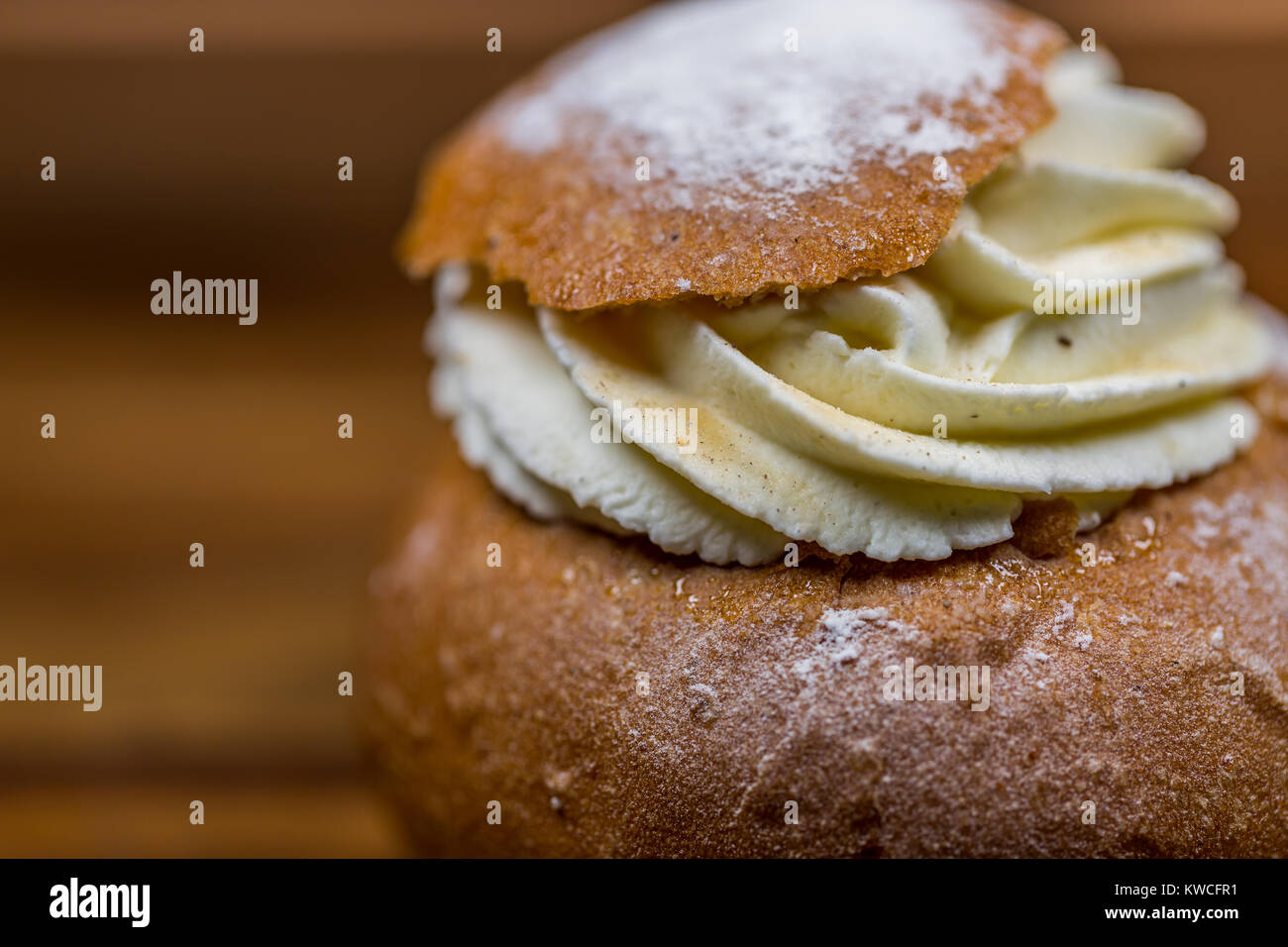 Semla Cake covered by sugar powder on wooden table.Close-Up Stock Photo ...