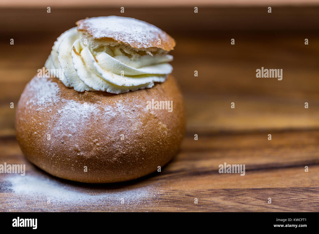 Semla Cake covered by sugar powder on wooden table.Close-Up Stock Photo ...