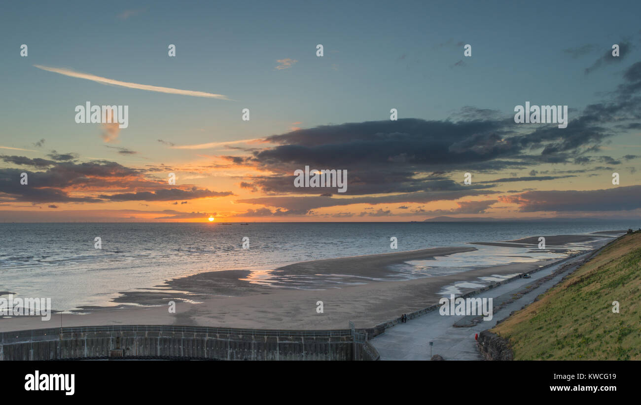 Sunset over beach Stock Photo - Alamy