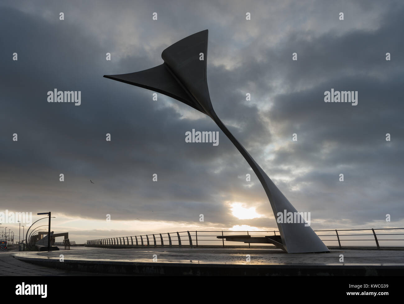 Promenade artwork.A steel sculpture of a fin against a dramatic sky ...