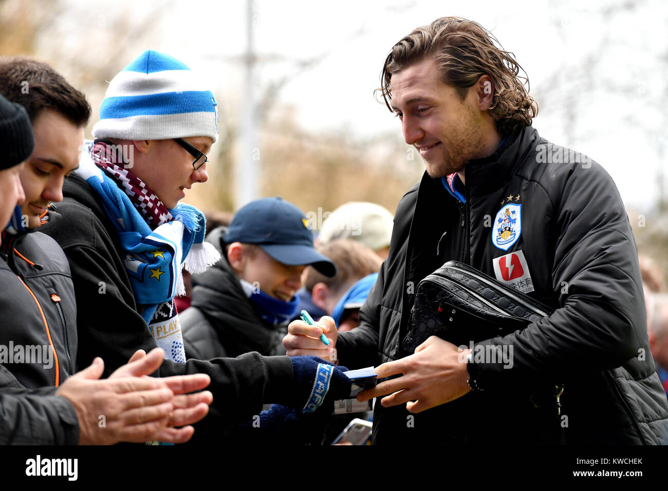 Huddersfield Town's Michael Hefele (right) signs autographs for fans ...
