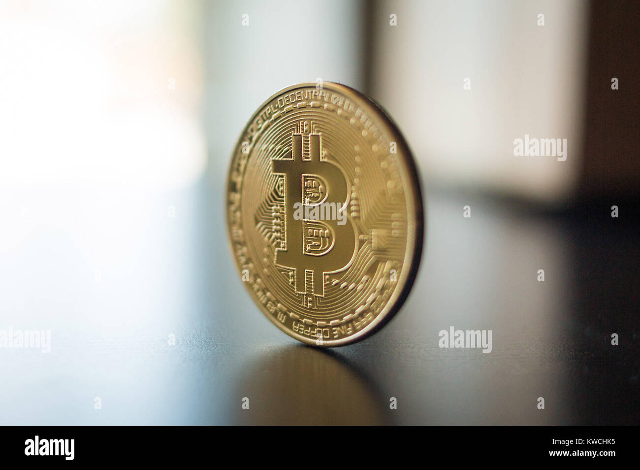 Single bitcoin coin close up on the surface standing Stock Photo - Alamy