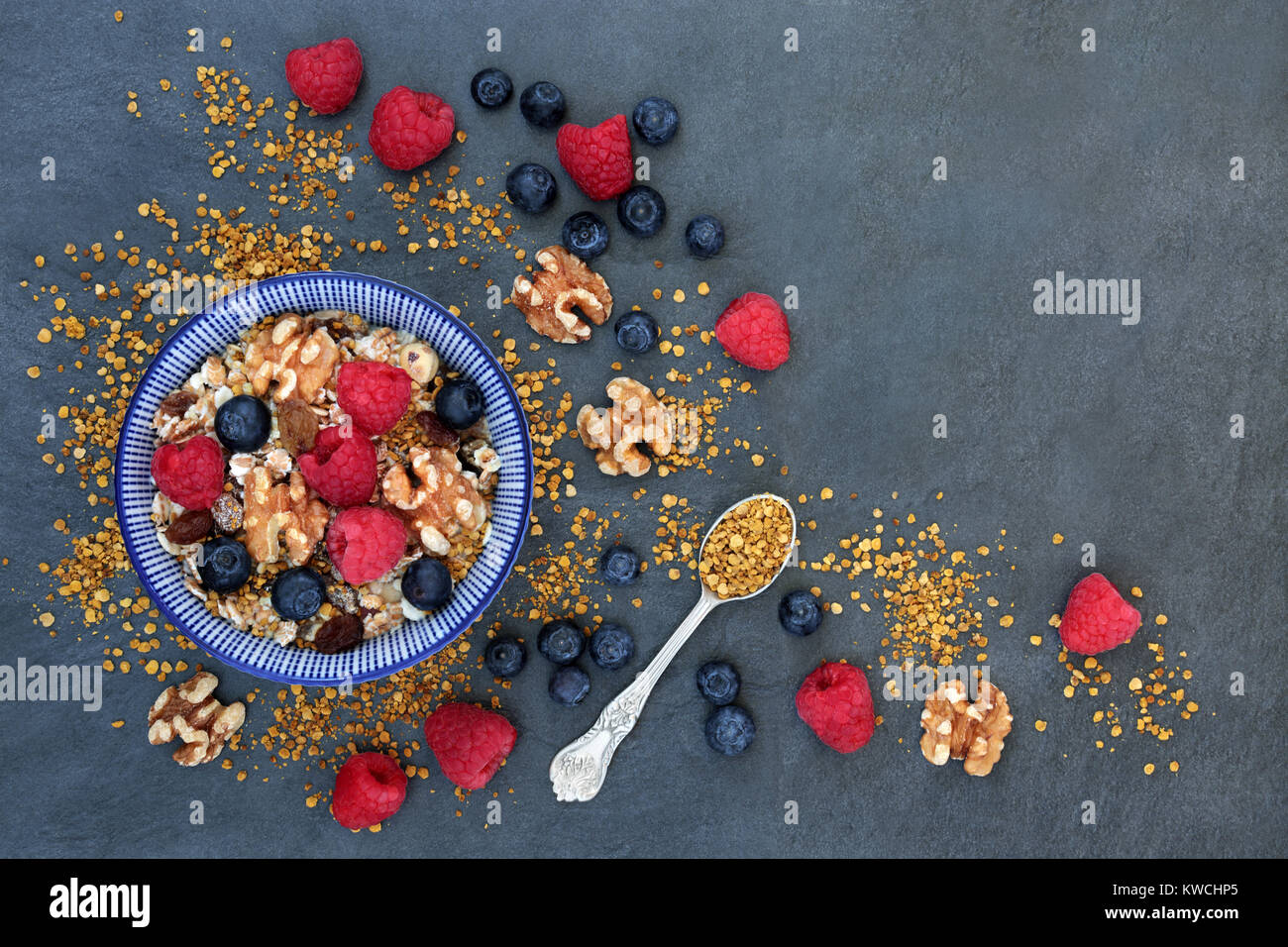 Healthy macrobiotic breakfast with berry fruit, nuts, pollen grain, and ...