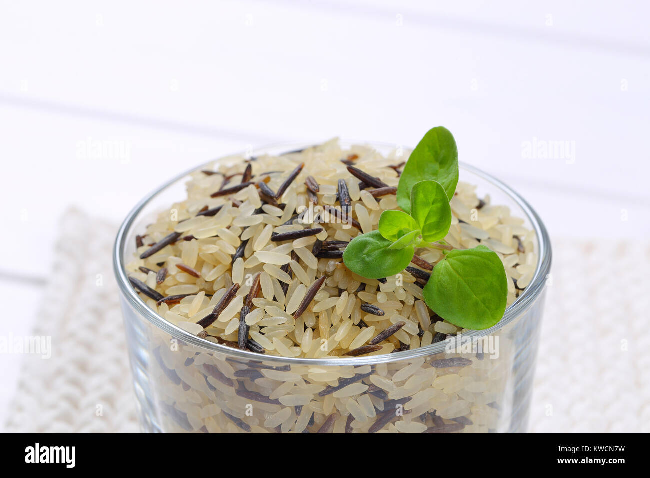 glass of wild rice on white table mat - close up Stock Photo - Alamy