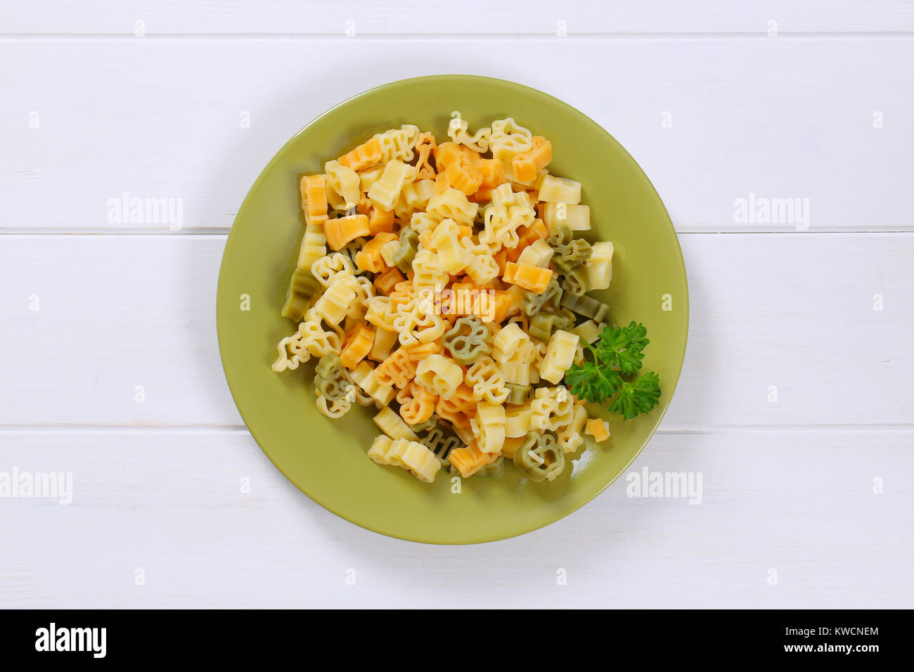 plate of cooked colored pasta on white wooden background Stock Photo ...