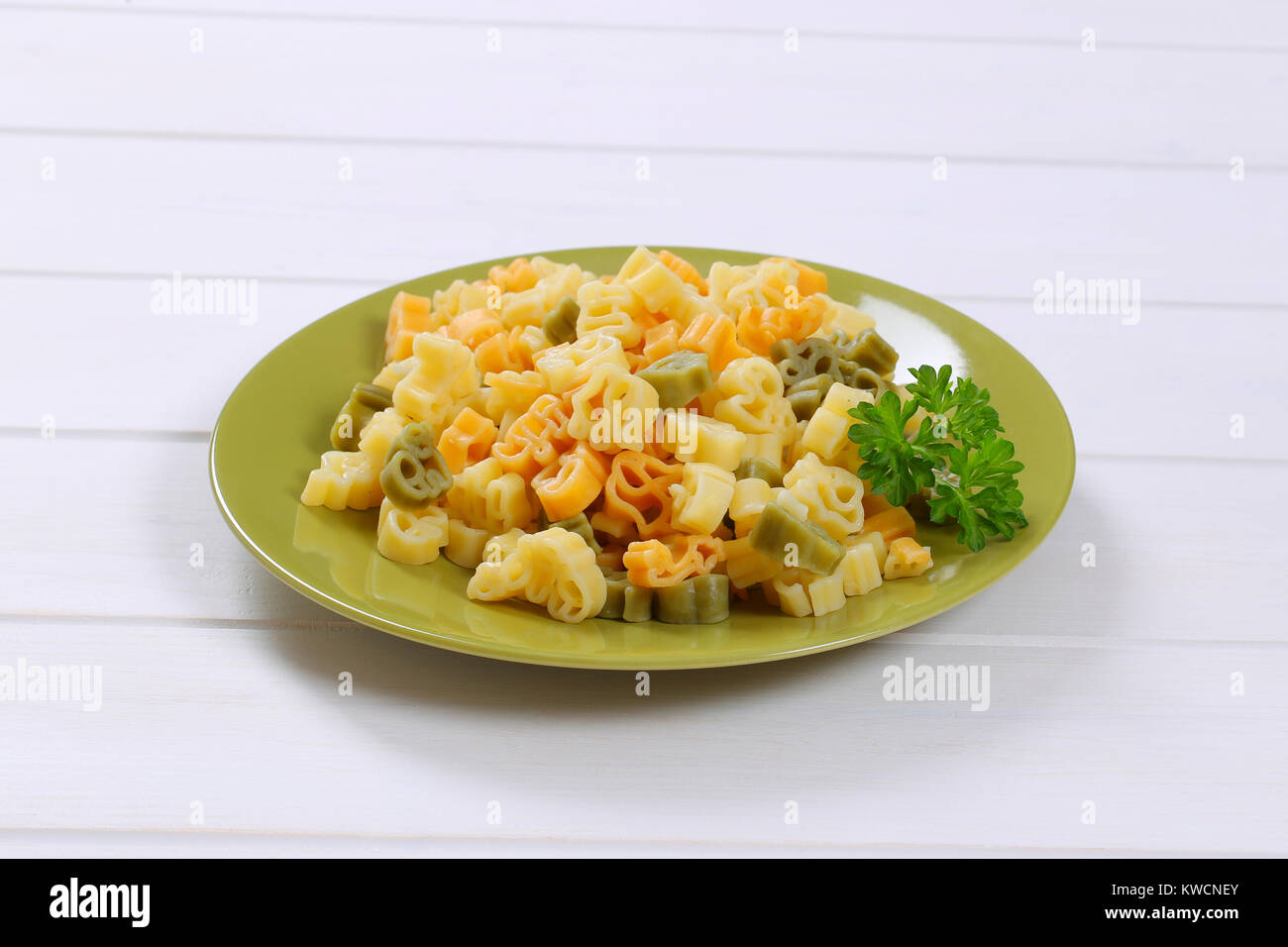 plate of cooked colored pasta on white wooden background Stock Photo ...