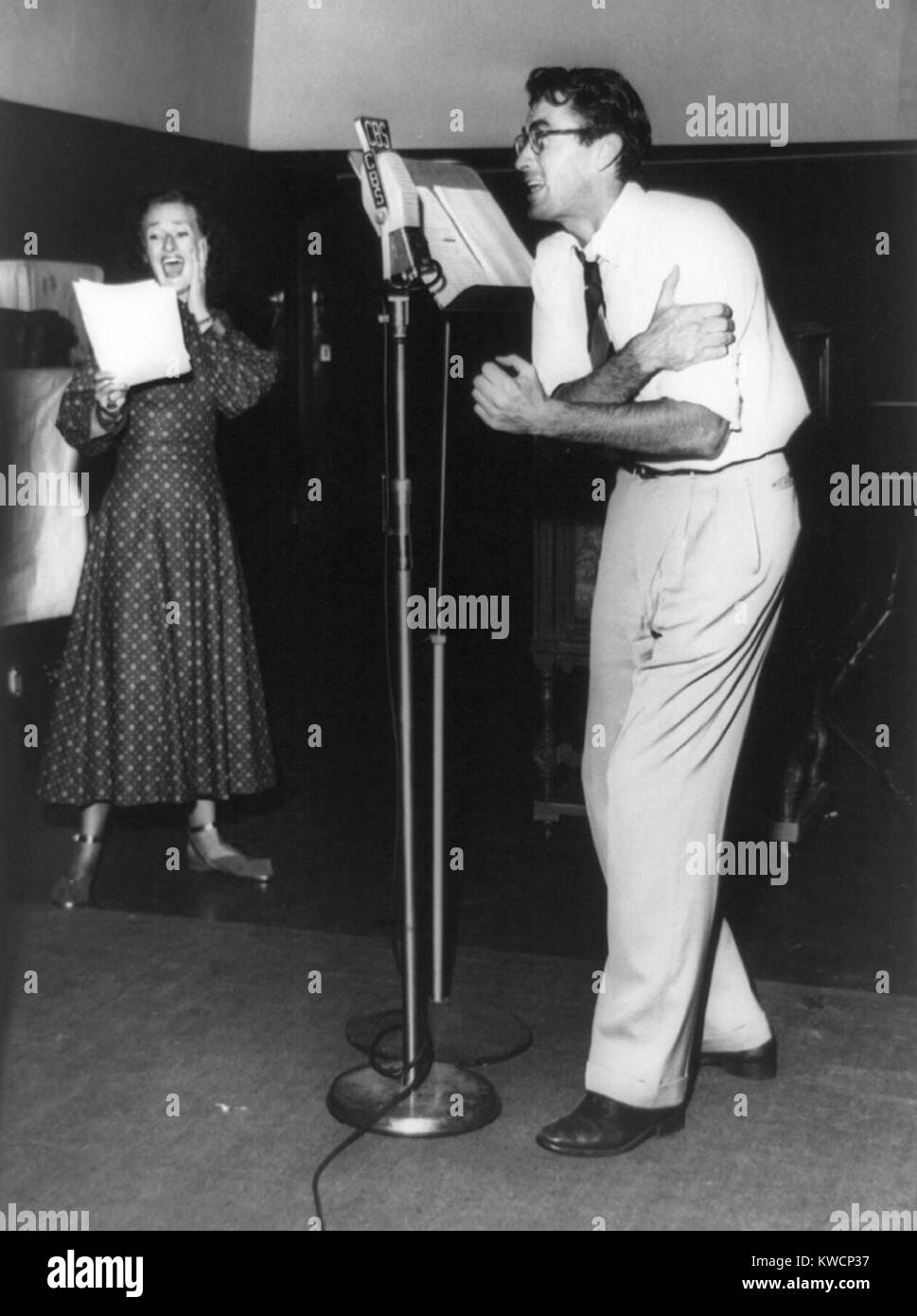 Gregory Peck at microphone with Kay Brinker in a radio play, 'Hitch ...
