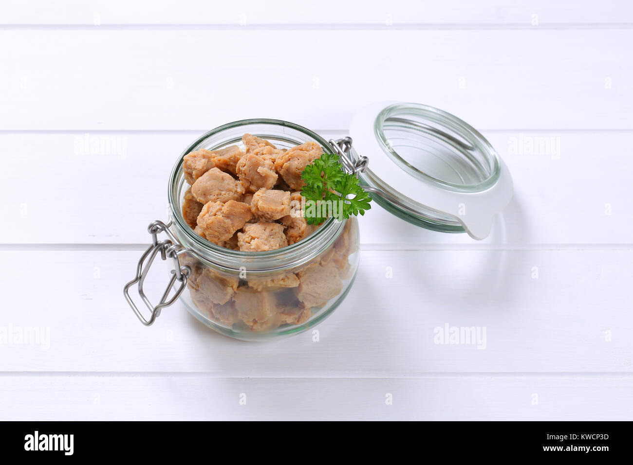 jar of soy meat cubes on white wooden background Stock Photo - Alamy