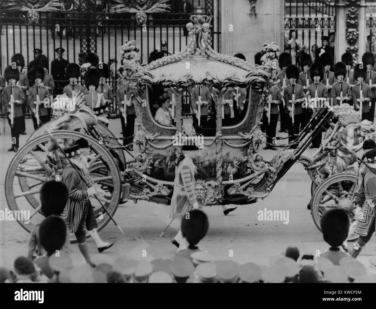 Queen Elizabeth II riding in the Gold State Coach enroute to her ...