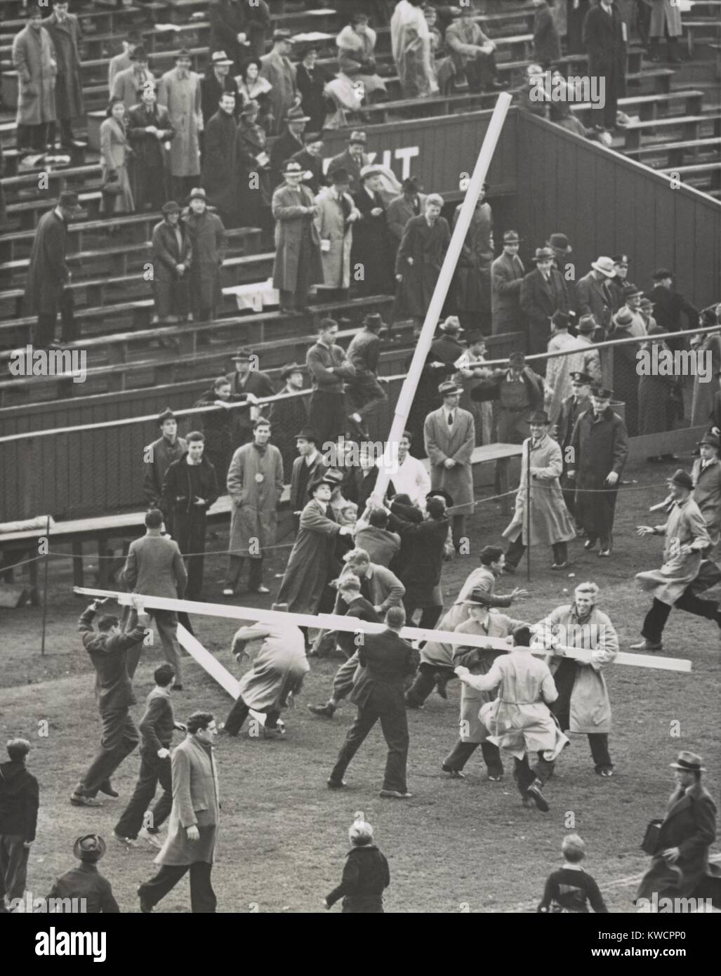 Brown University students tear down the goal posts in celebration of a ...