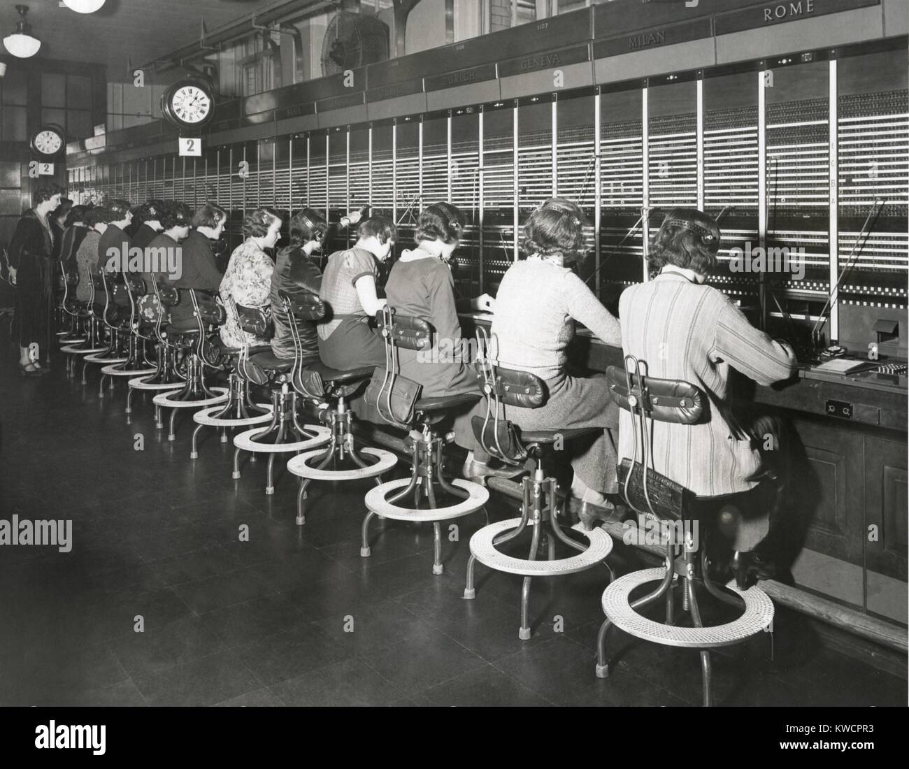Telephone operators working on an international switchboard in the ...
