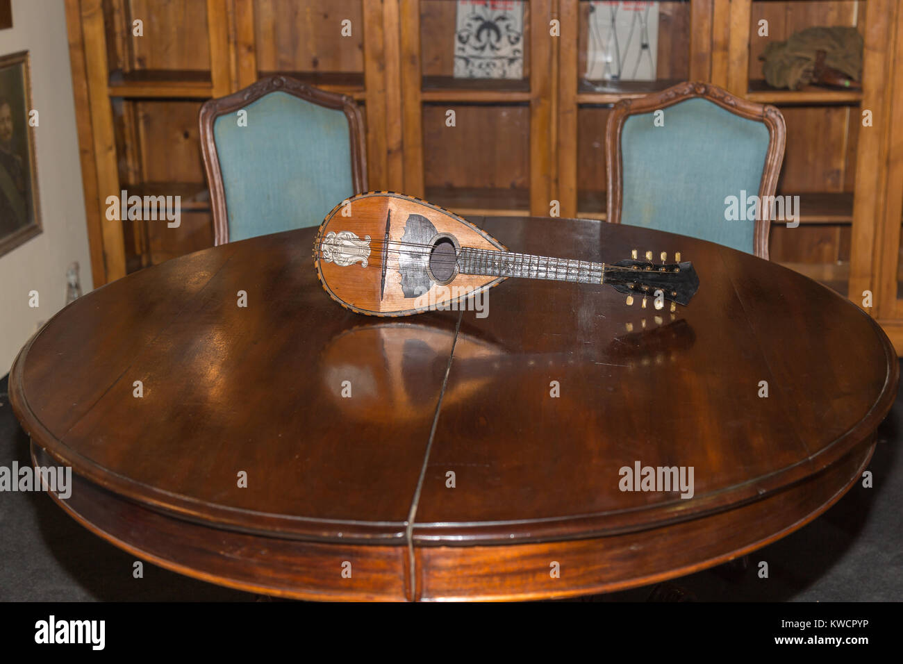 Antique Mandolin on Wooden Round Table with Two Chairs Stock Photo - Alamy