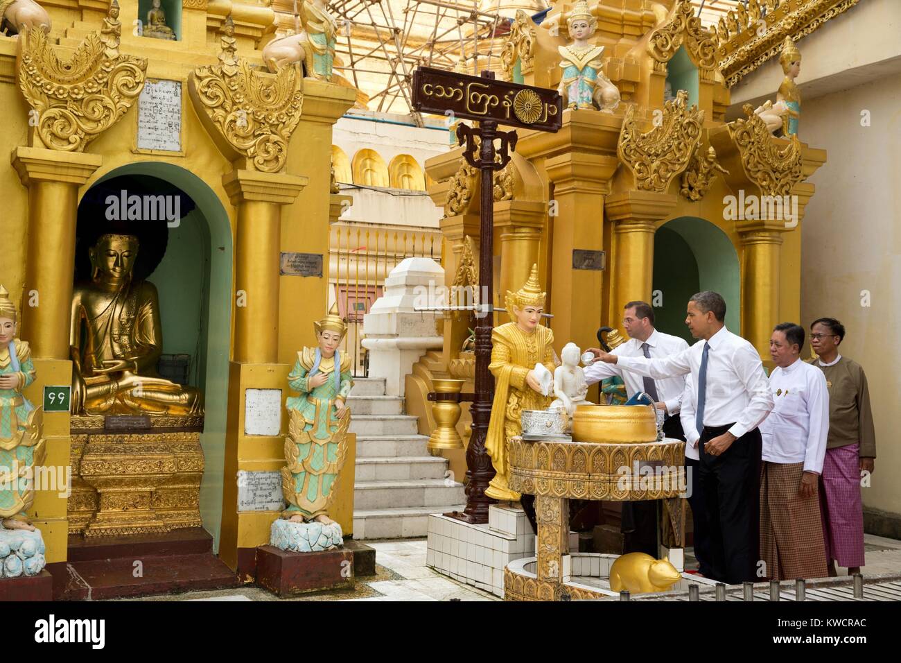 President Barack Obama pours water over the left shoulder of the Friday ...