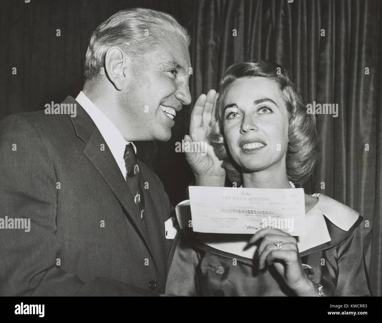 Dr. Joyce Brothers holds her check for correctly answering the $64,000 ...