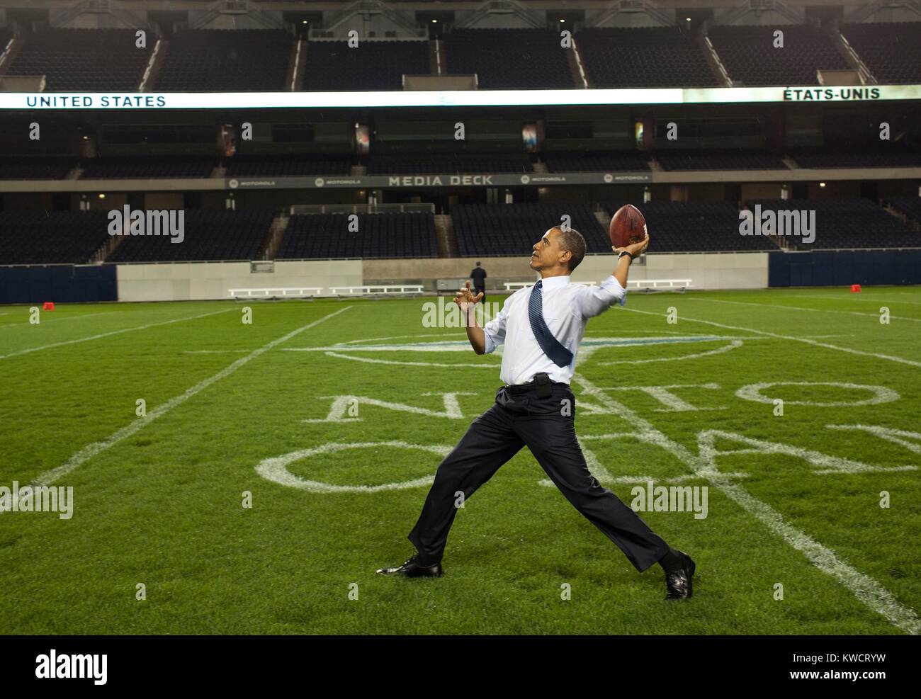 President Barack Obama throws a football at Soldier Field. Chicago ...