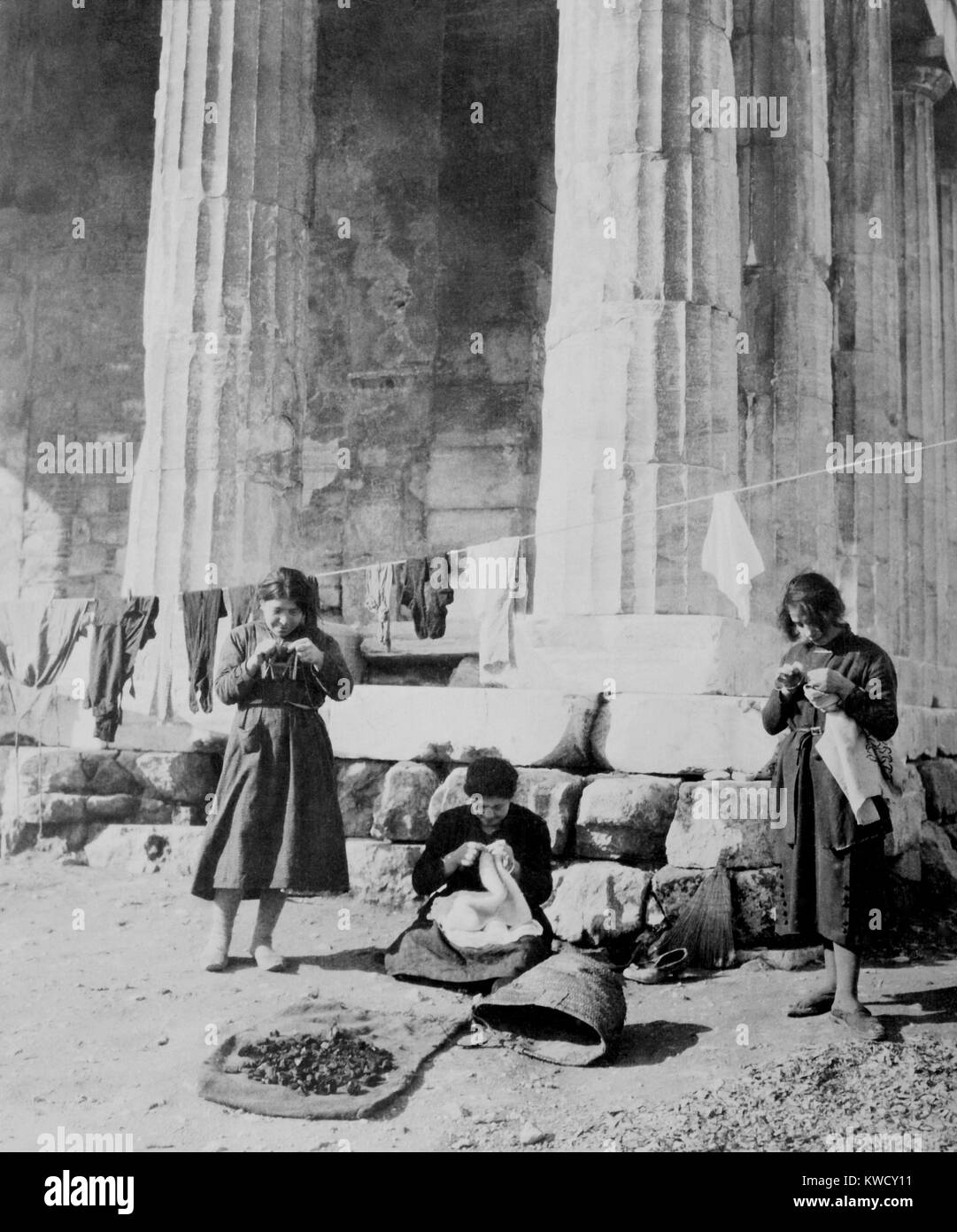 Greek refugee women doing needlework in front of the Temple of Theseus ...