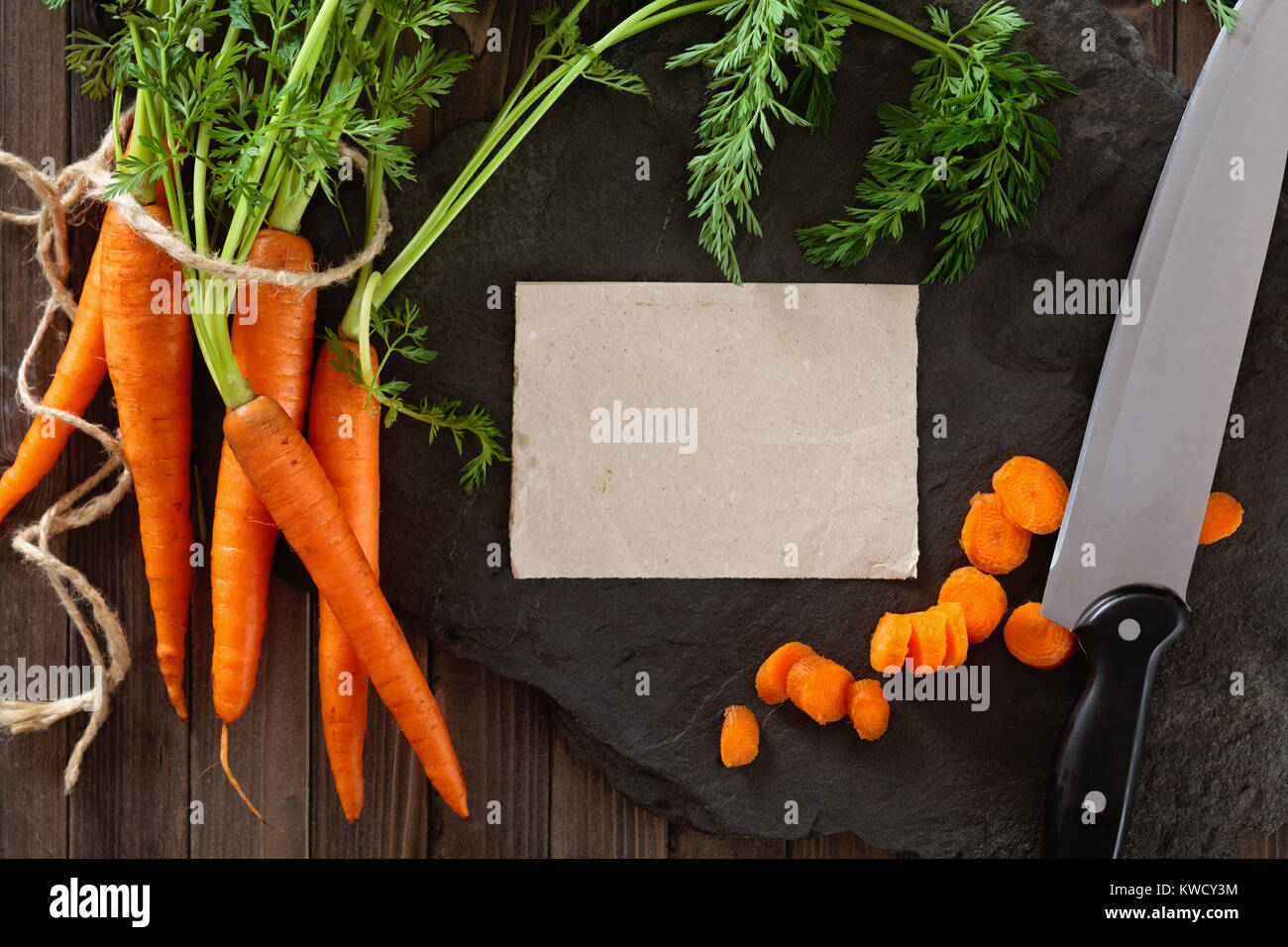Heap of ripe carrots with leaves on dark slate Stock Photo - Alamy