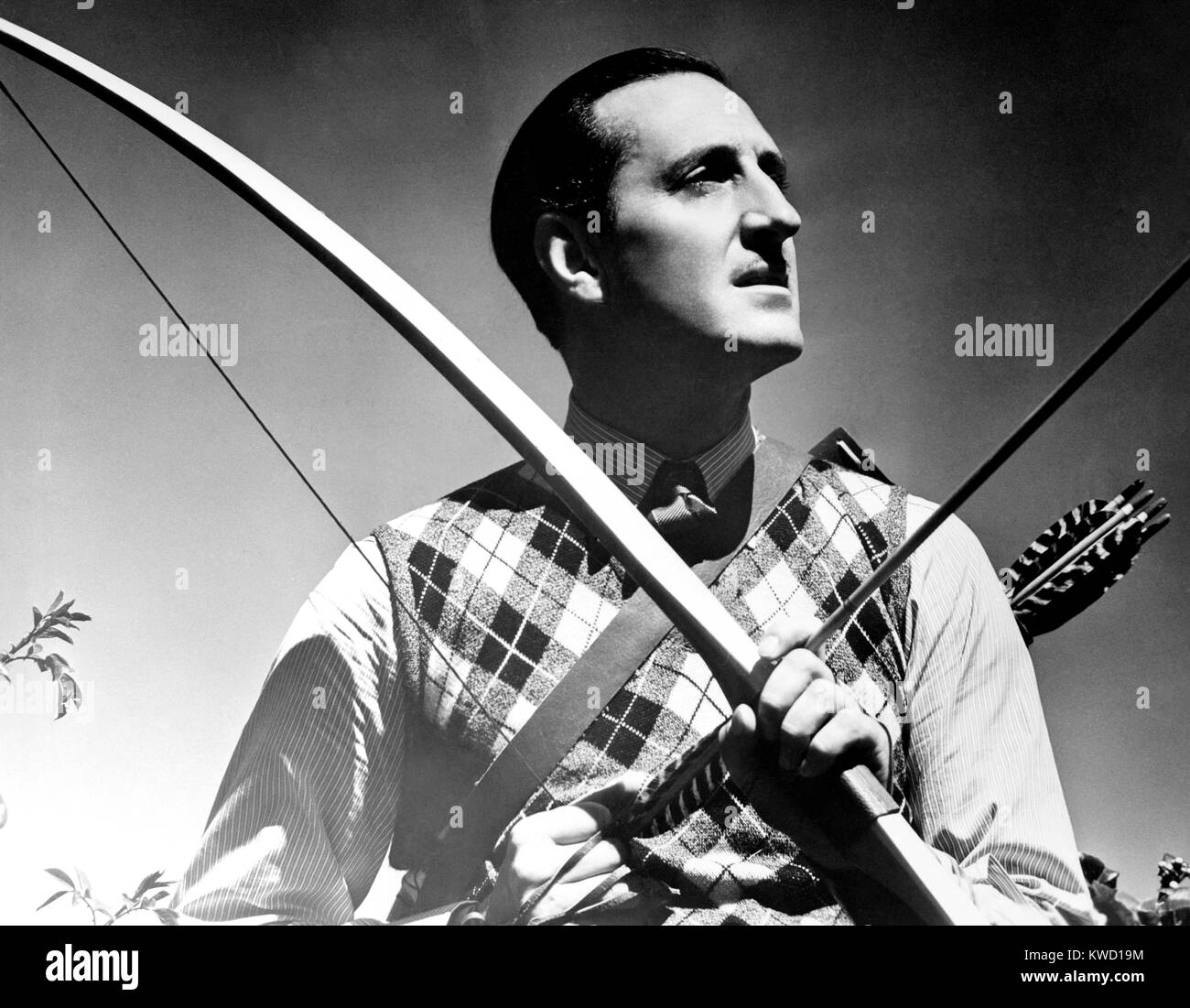 Basil Rathbone engaged in his favorite sport archery, 1940 Stock Photo ...
