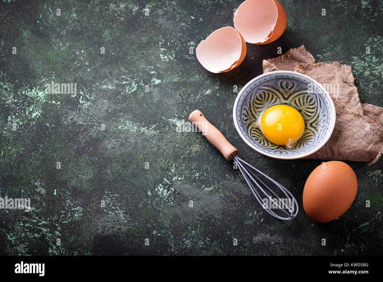Raw chicken eggs and whisk Stock Photo - Alamy