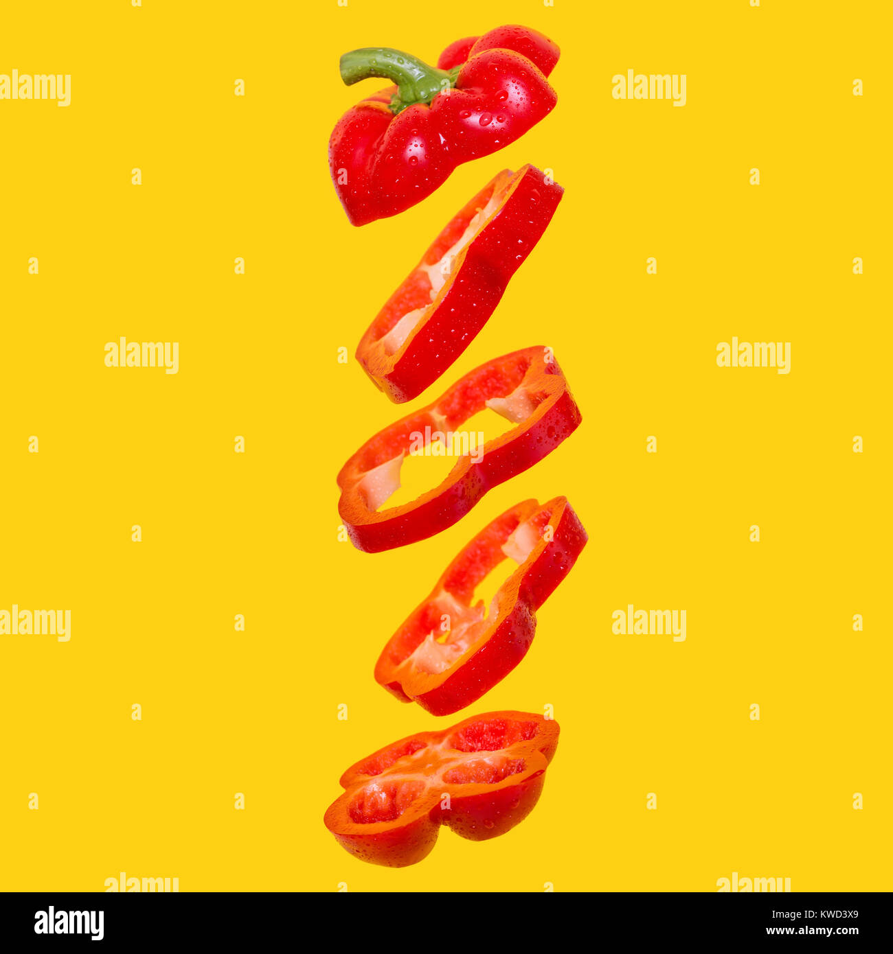Creative concept with flying red capsicum. Sliced floating bell pepper ...