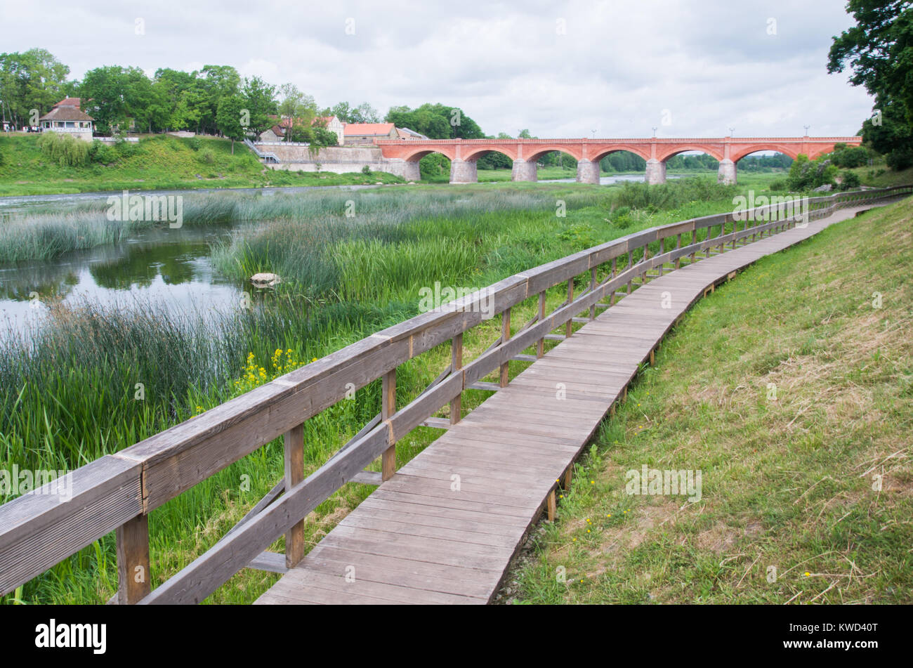 A view of Kuldiga's red brick bridge, the longest in Europe, with a ...