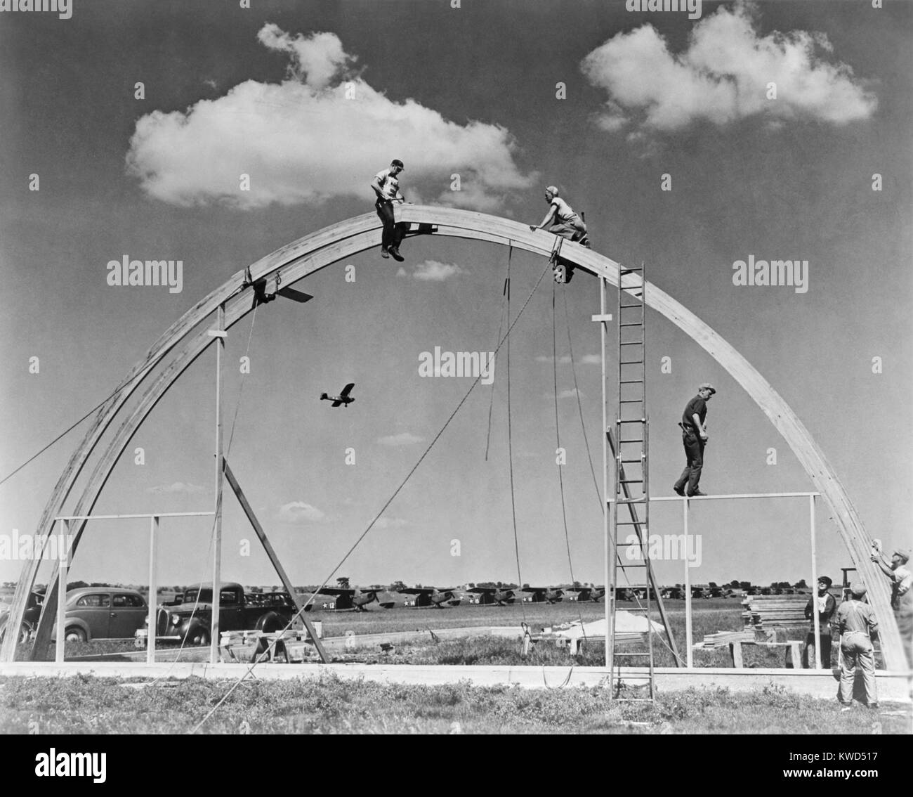 Construction workers on airplane hangar with prefabricated 'Rilco ...