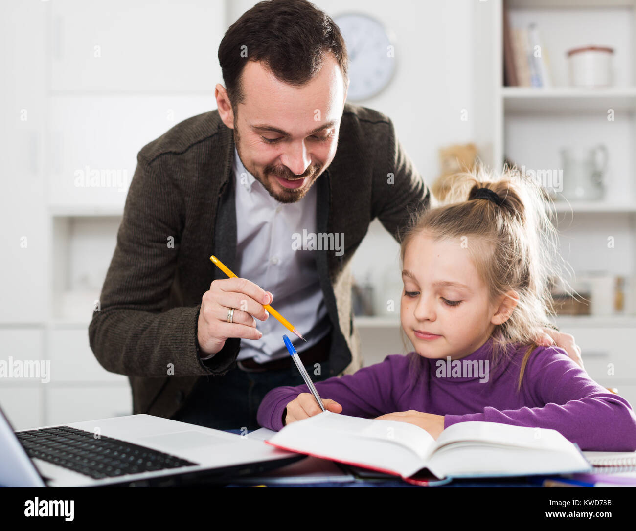 Father helping his child to do homework at home Stock Photo - Alamy
