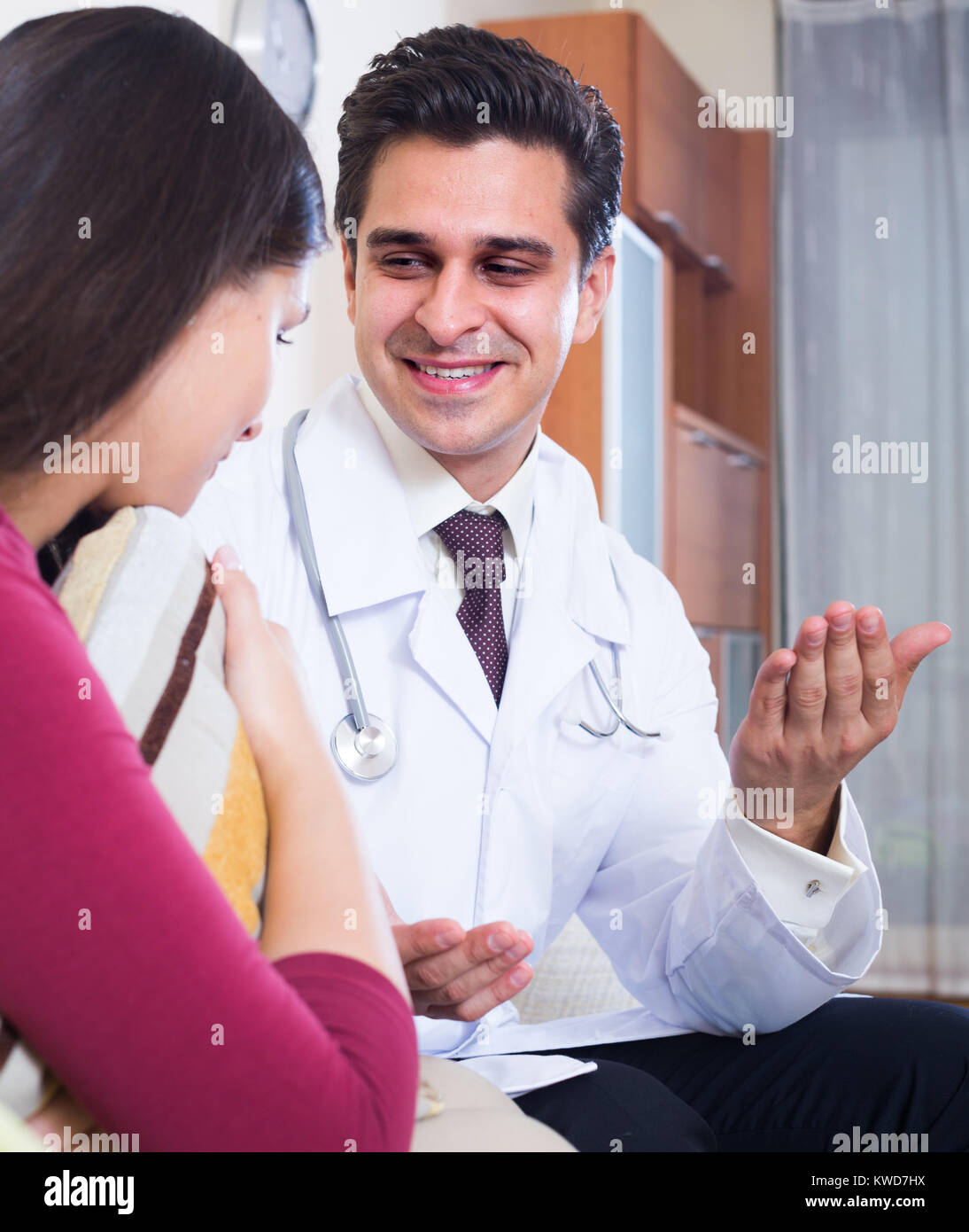 Professional doctor paying female patient a visit for checkup Stock ...
