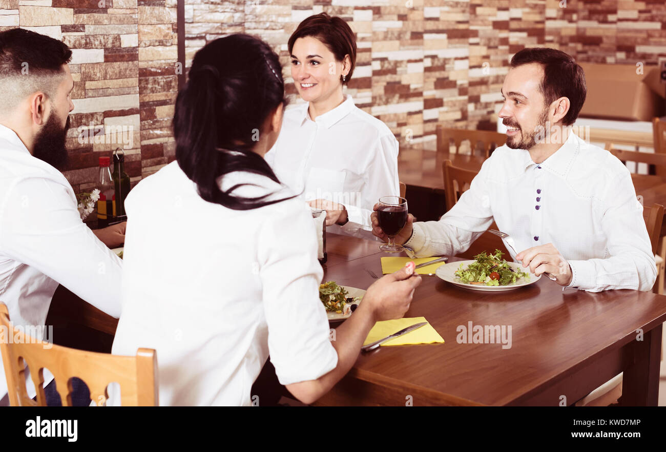 Smiling group of friends having dinner at restaurant table Stock Photo ...