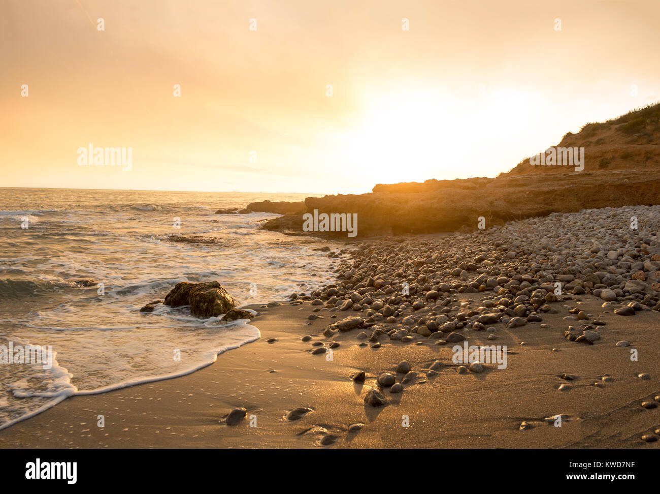 The calm sea in a very cloudy sunset in Spain Stock Photo - Alamy