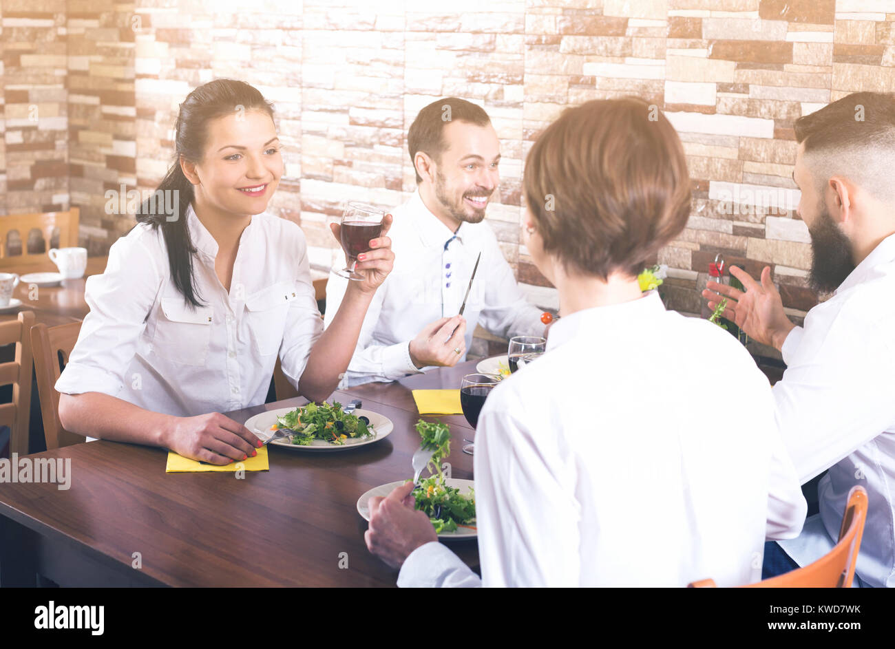 Company of four spends time at dinner in a restaurant Stock Photo - Alamy