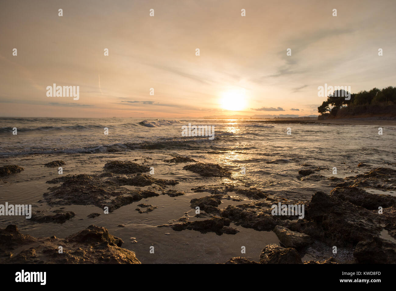 The calm sea in a very cloudy sunset in Spain Stock Photo - Alamy