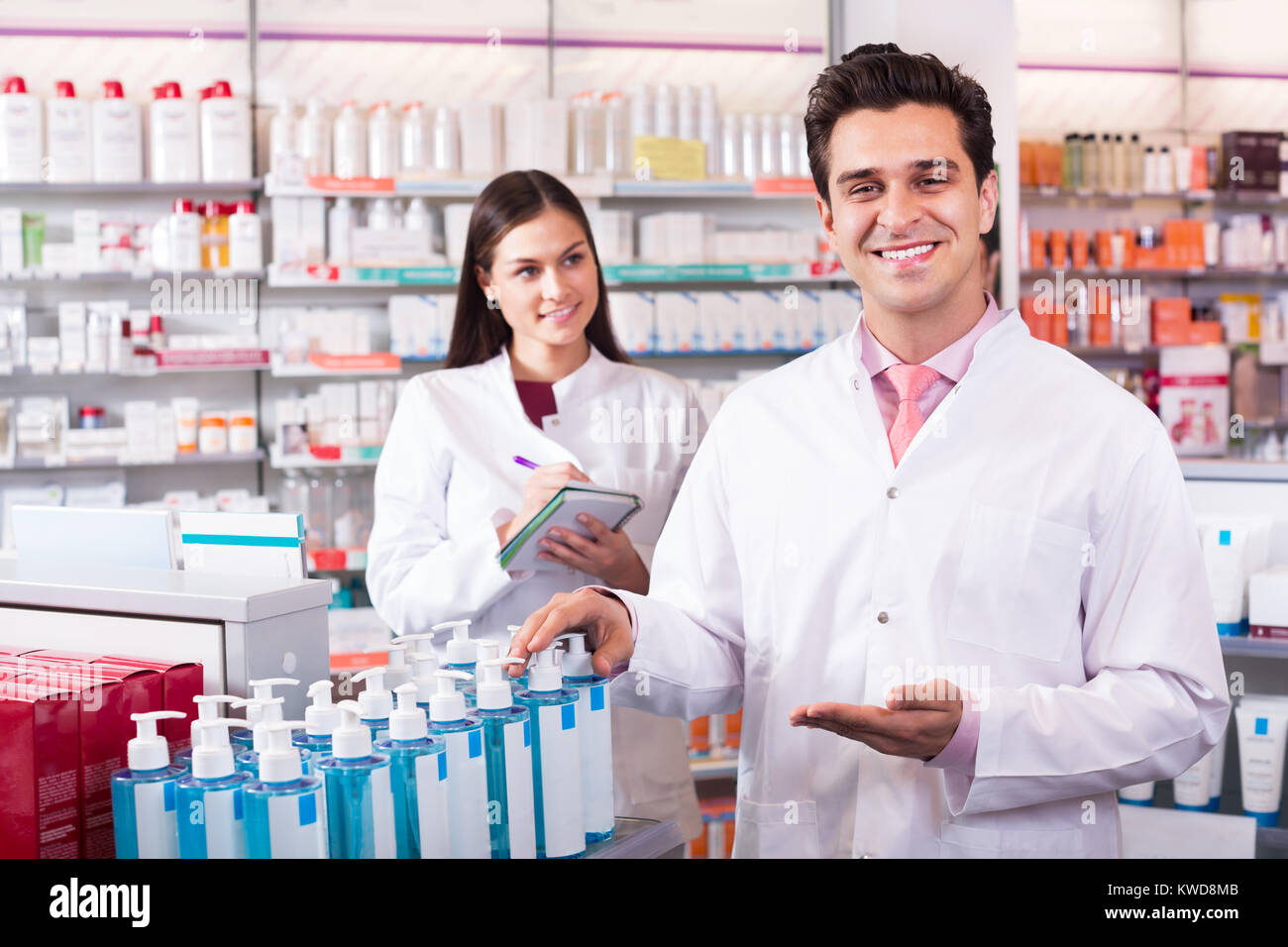 Young team of a pharmaceutist and technician working in a chemist shop ...