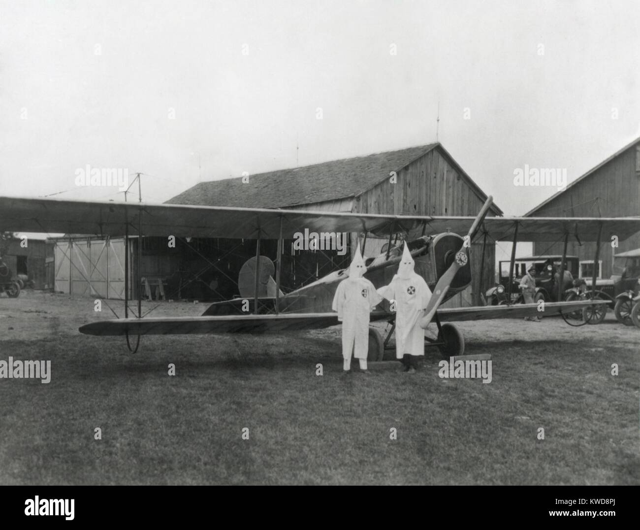 Two pilots in Ku Klux Klan shrouds pose with their aircraft in Dayton ...