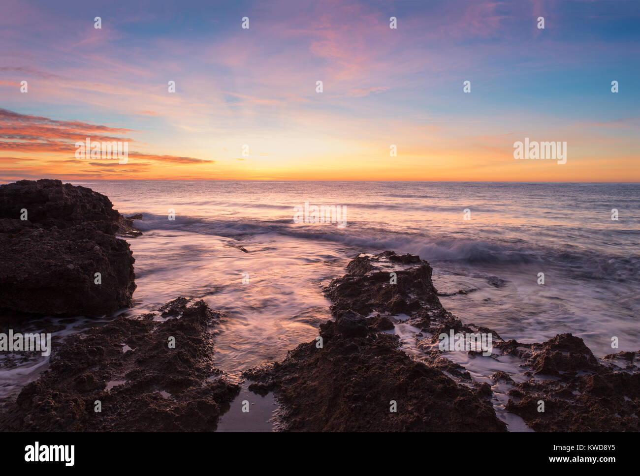 The calm sea in a very cloudy sunset in Spain Stock Photo - Alamy