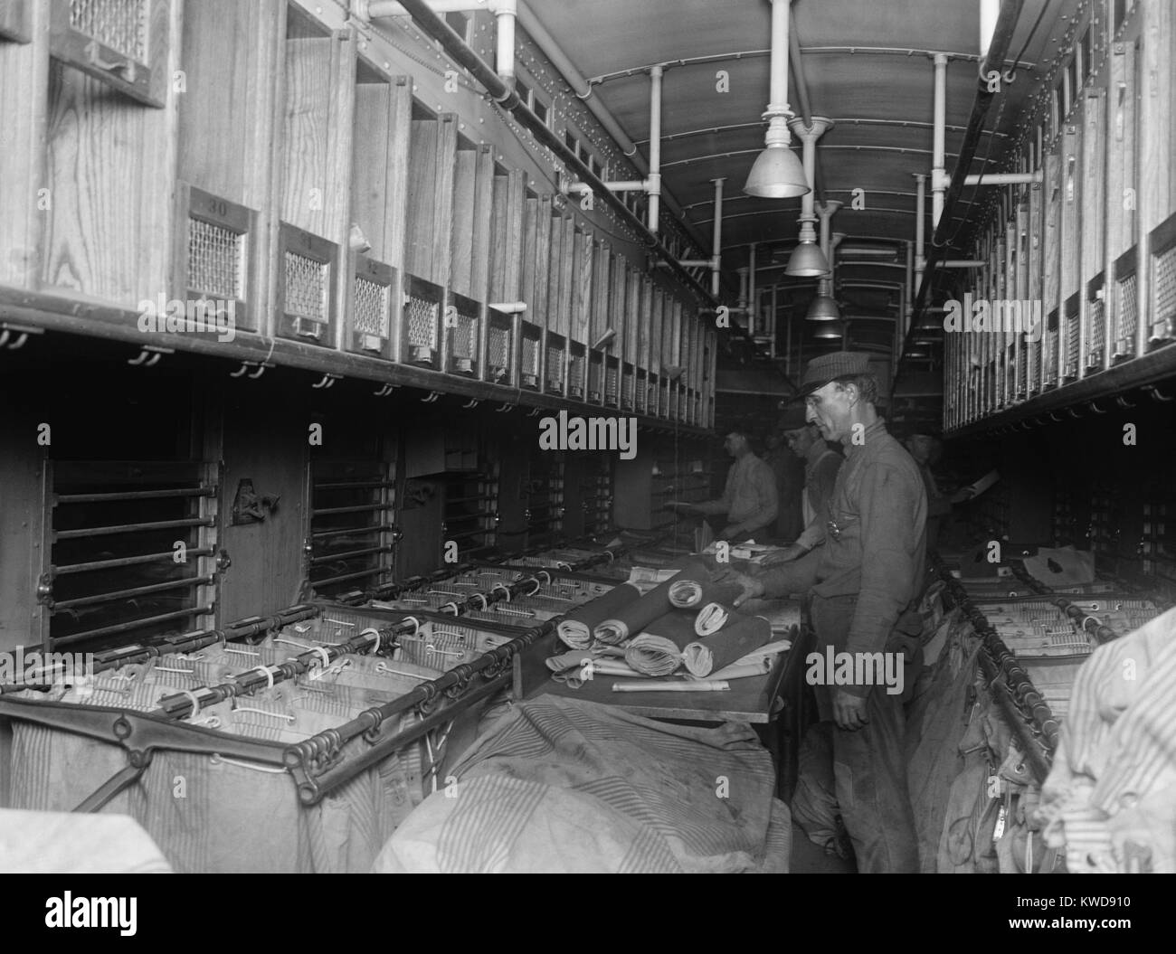 Railway Post Office (RPO) clerks sorting mail aboard a customized rail ...