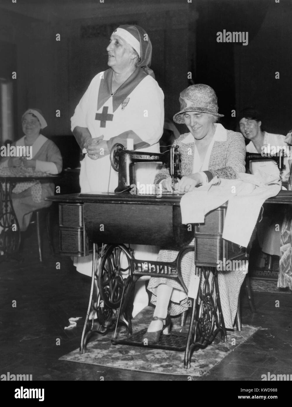First Lady Lou Hoover uses a sewing machine at Red Cross Headquarters ...