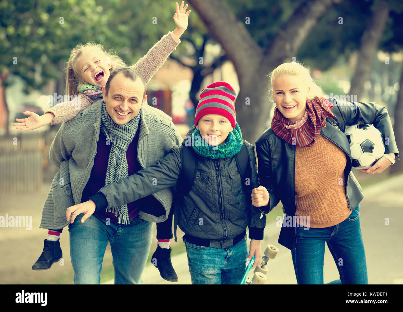 Cheerful active family with two smiling children spending weekend ...