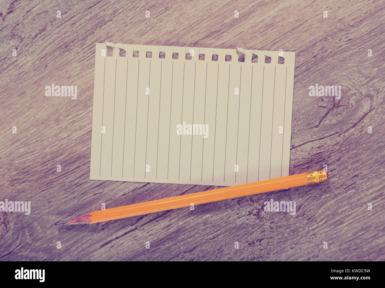 Torn sheet of notebook with pencil Stock Photo - Alamy