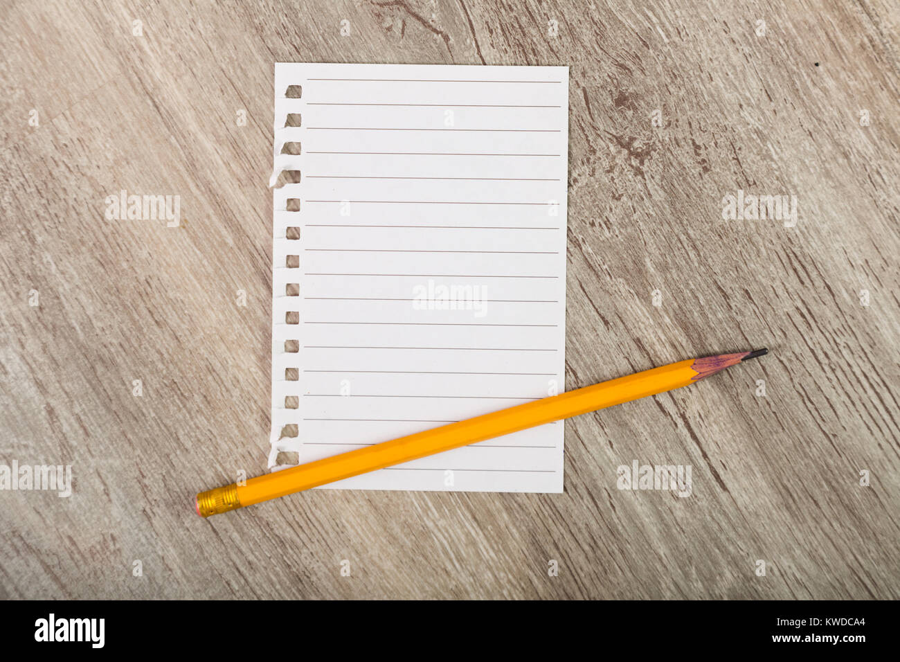 Torn sheet of notebook with pencil Stock Photo - Alamy