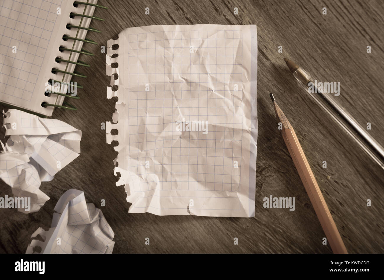 Empty crumpled pages and notebook lying on wooden surface Stock Photo ...