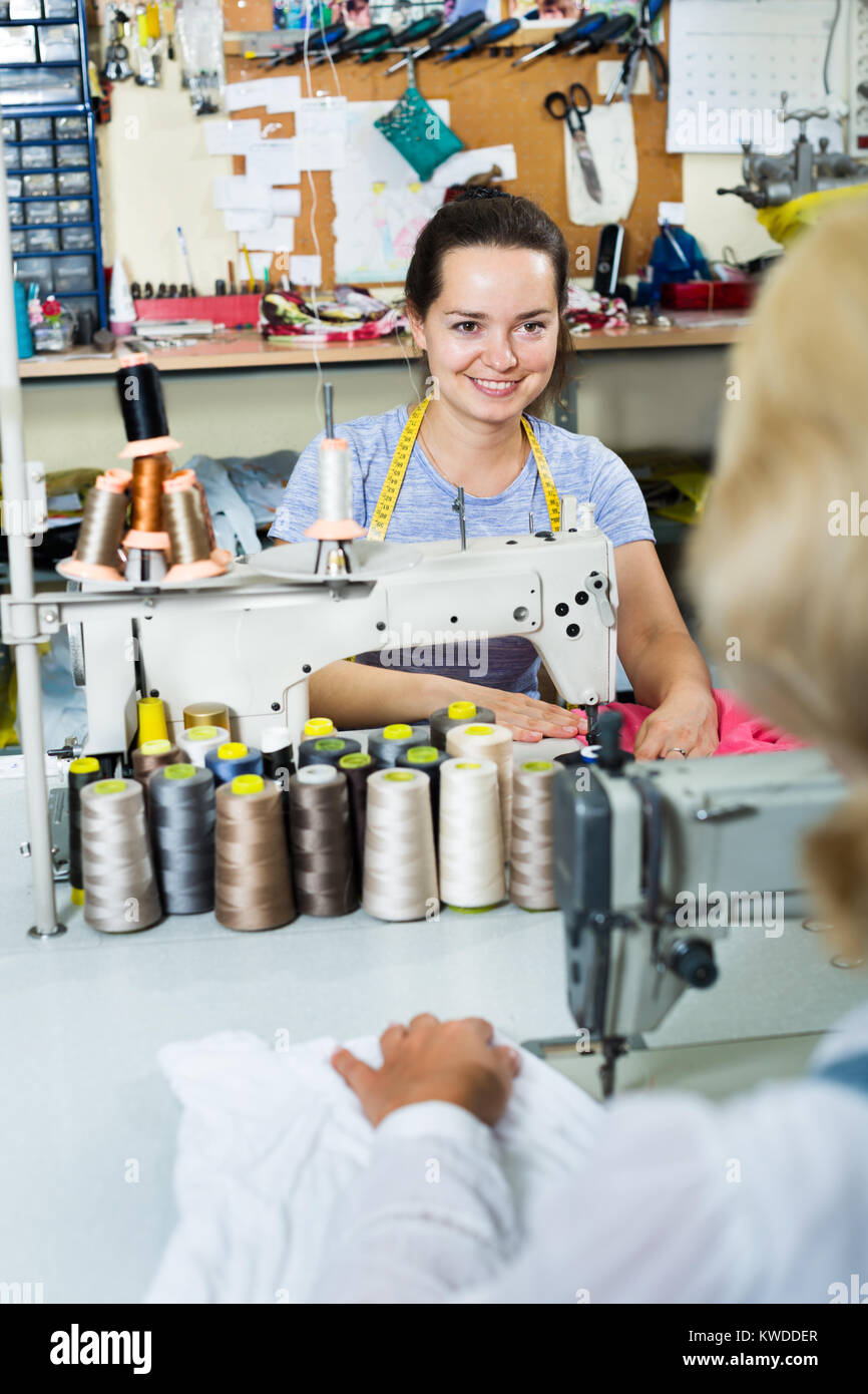 Portrait of two professional female tailors working in the sewing ...