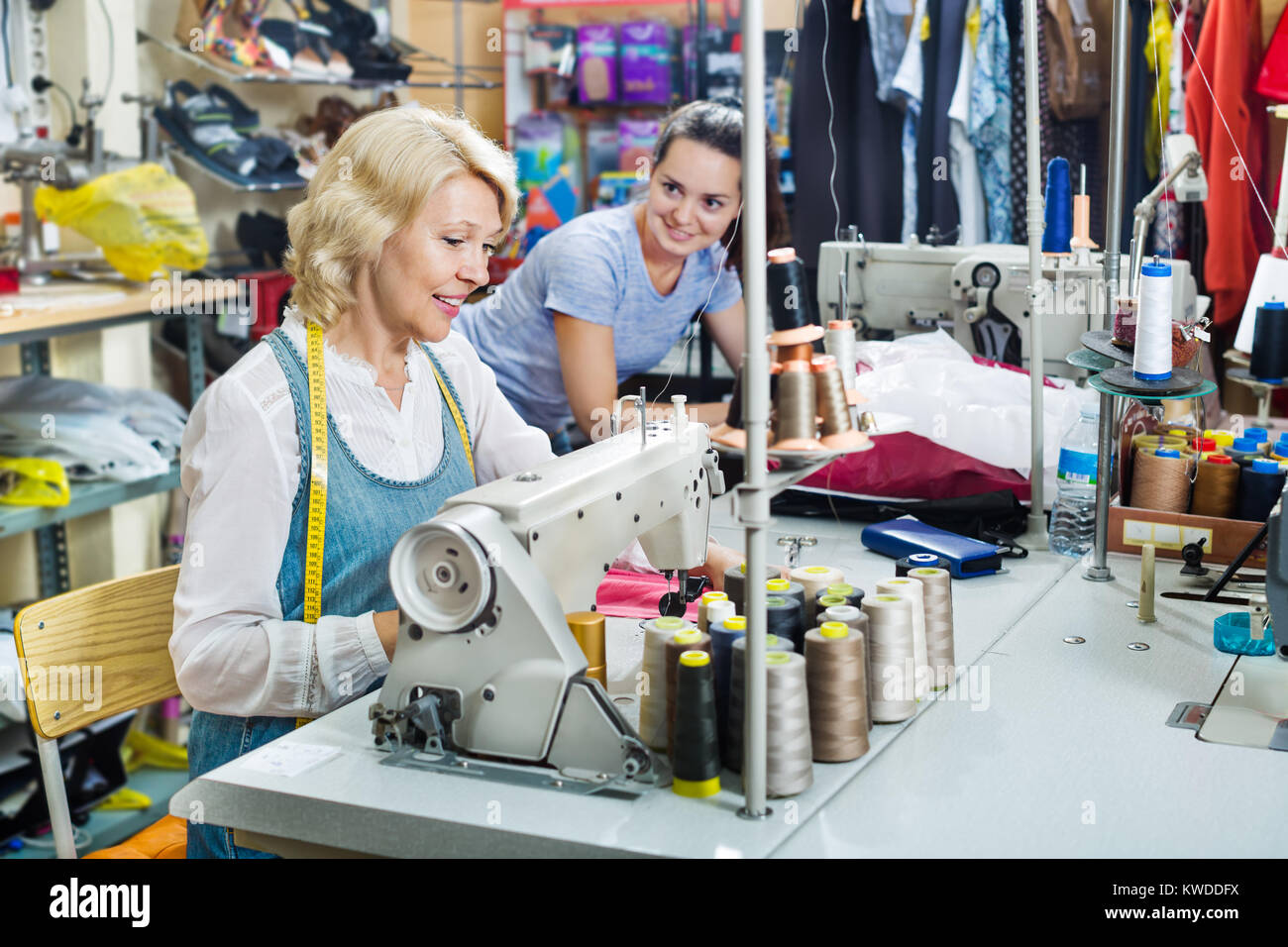 Portrait of two professional experienced female tailors working in the ...