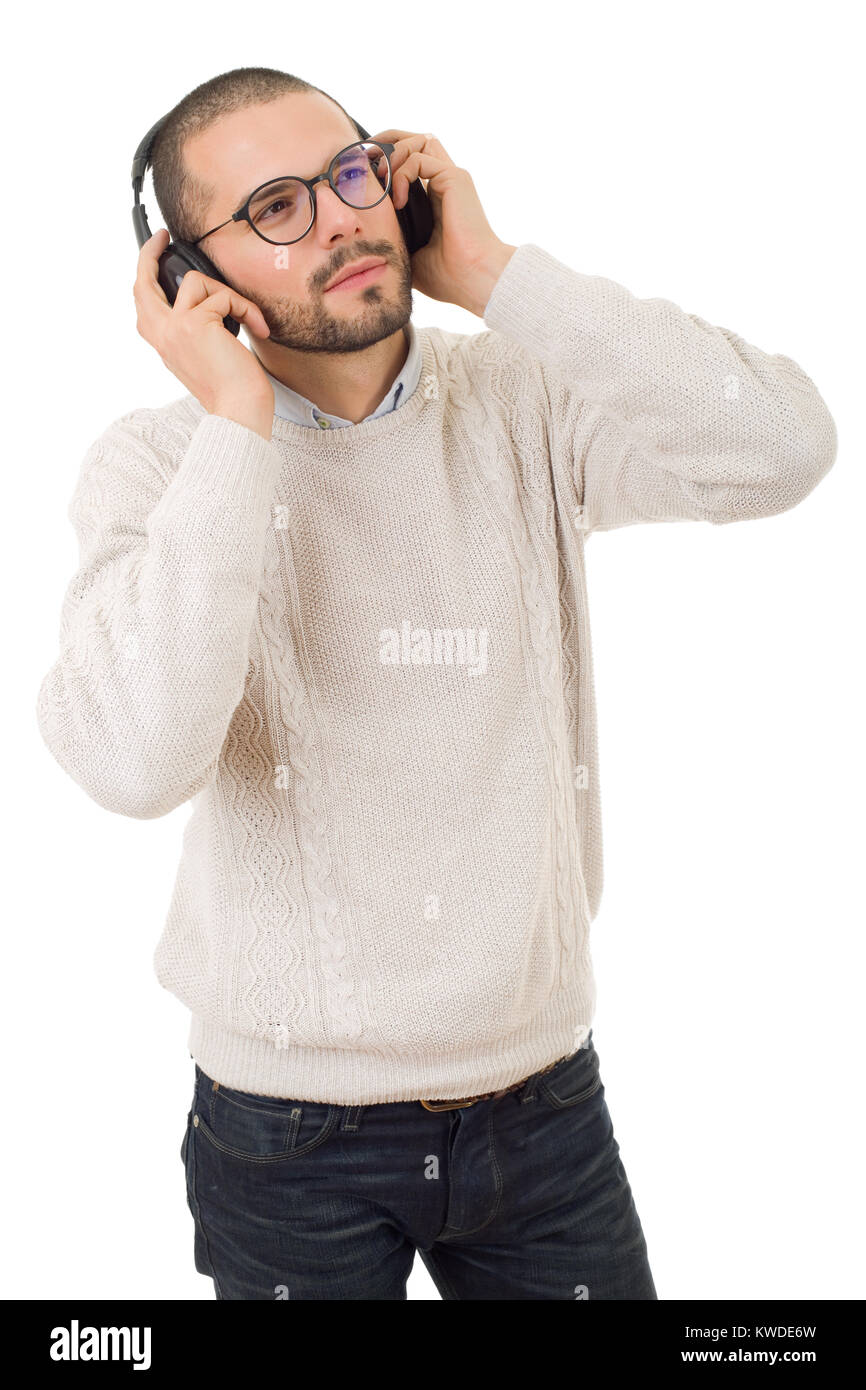 Casual young man listening music with headphones, isolated on white ...