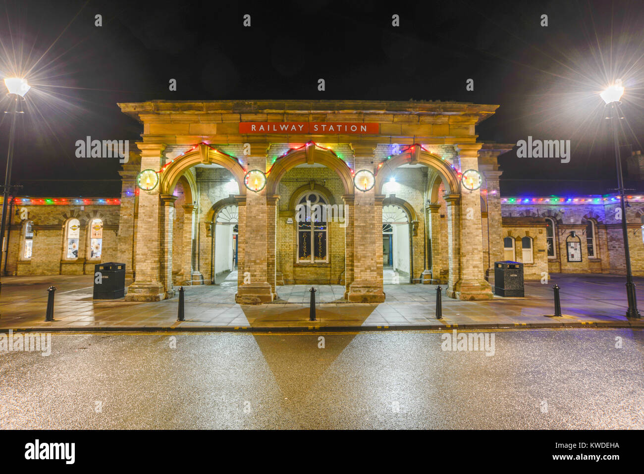 Portico of Saltburn railway station at night with Christmas decorations ...