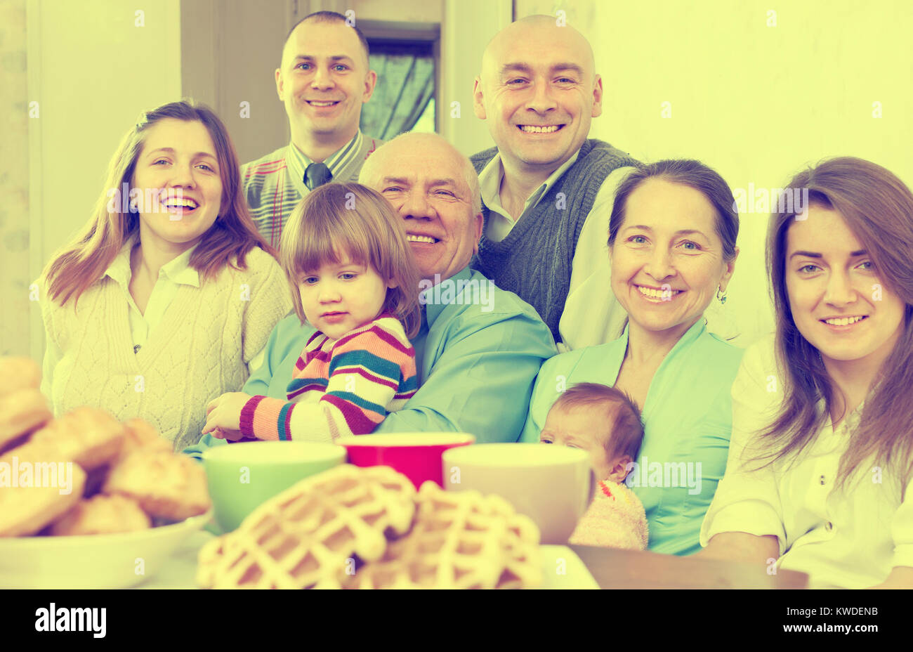 large joyful three generations family sits in home Stock Photo - Alamy