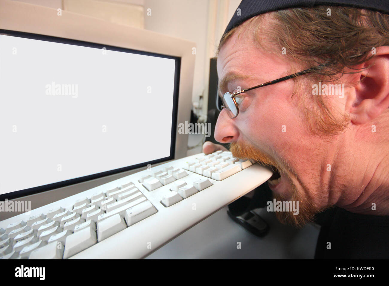 mad programmer sitting at a computer desk Stock Photo - Alamy
